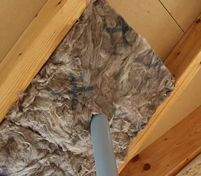 Cutting insulation between rafters for pipe openings