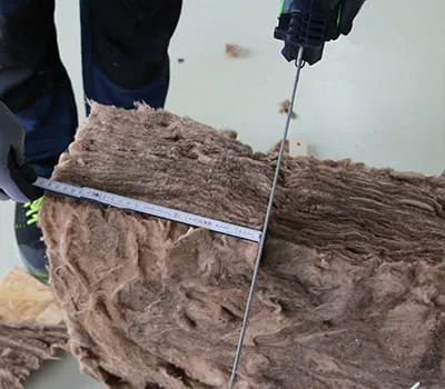 Cutting insulation between rafters for pipe openings