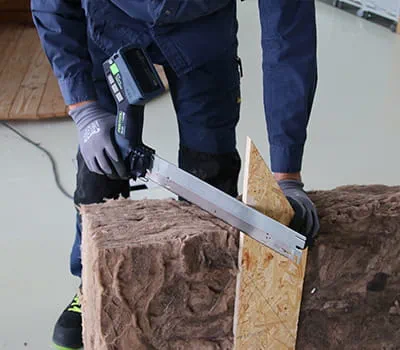 Cutting insulation between rafters for pipe openings